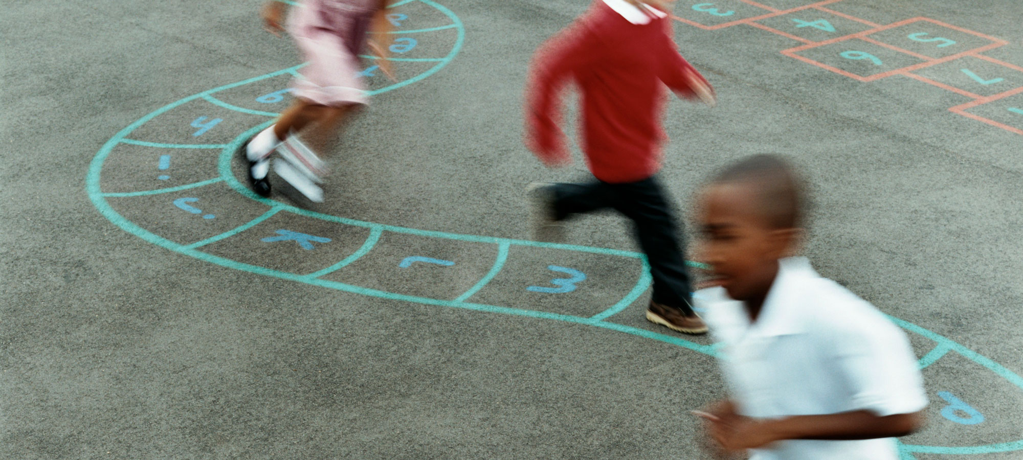 Primary School Children Chasing Each Other in a School Playground ...