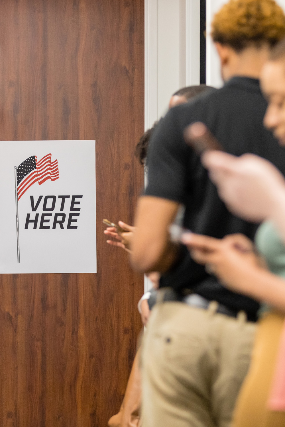Diverse Group Uses Phones While Waiting To Vote - Public Policy ...