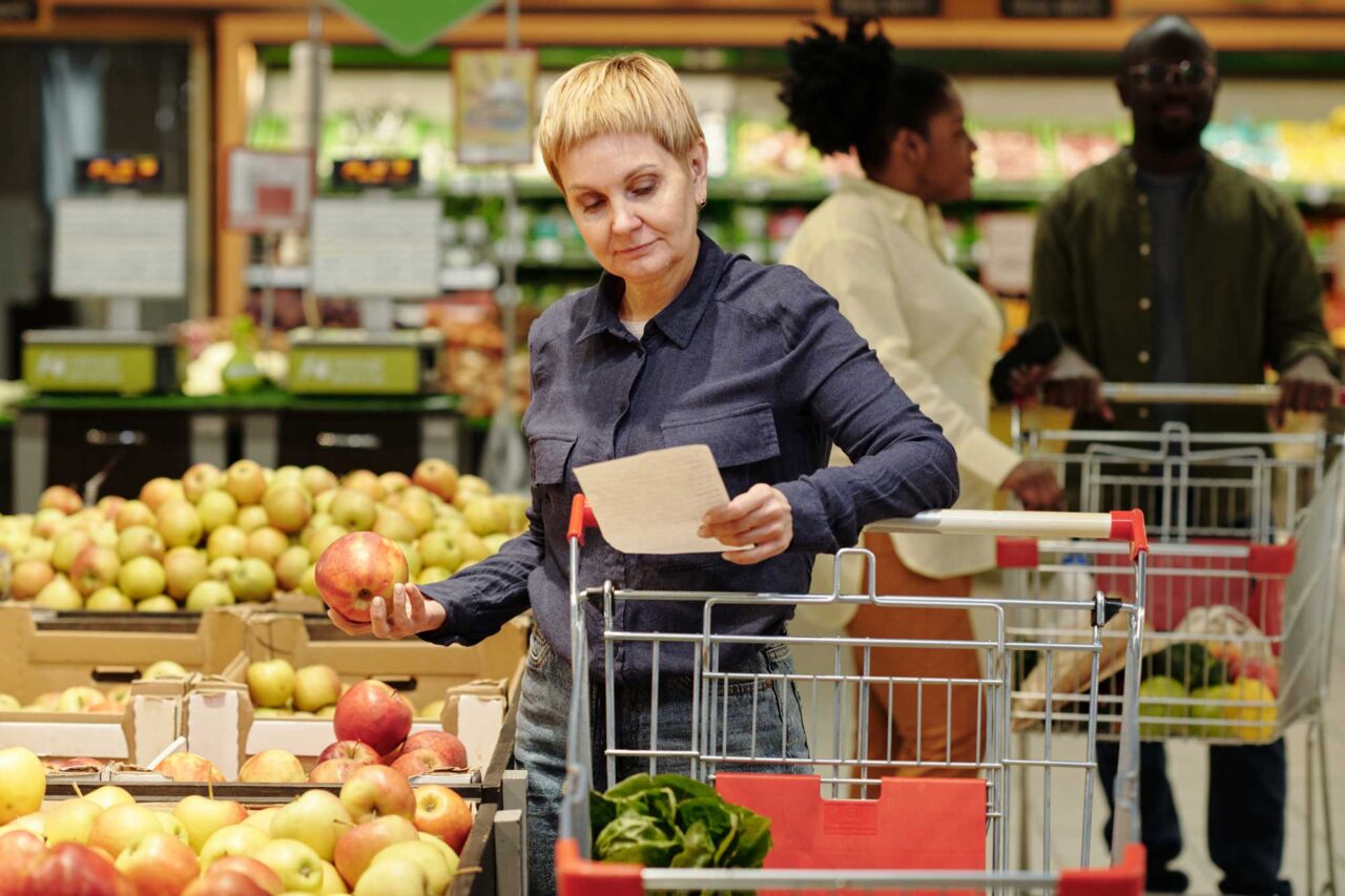 Woman Looking at Shopping List in Grocery Store - Public Policy ...